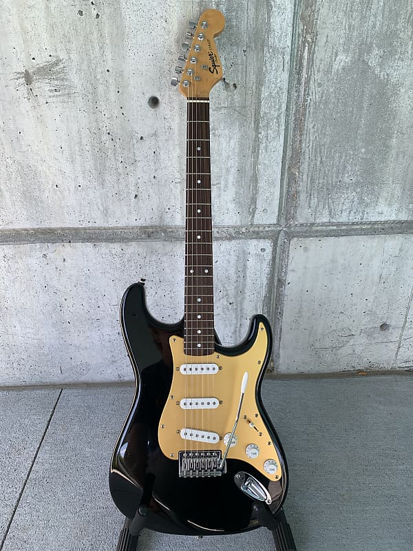 Squier Stratocaster Black w/ Gold Anodized Aluminum Pickguard | Reverb