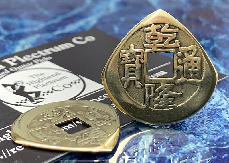 The Highland Plectrum Co. One Feng Shui Brass Coin Plectrum. | Reverb